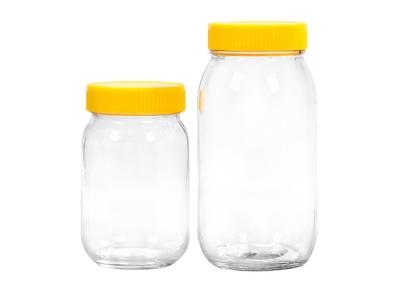 中国 黒いふた500ml 1000mlが付いている円形の明確な蜂蜜の瓶の六角形のガラス瓶 販売のため
