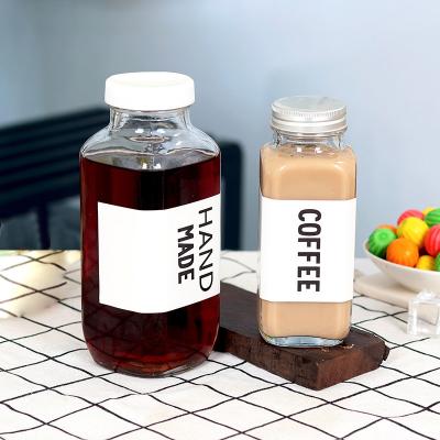 中国 正方形の明確なガラス飲料はプラスチックねじふたが付いている500ml注文のラベルをびん詰めにする 販売のため