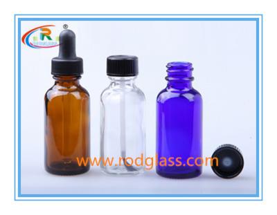 China 1oz Amber glass bottle Boston Round with black phenolic cone lined cap for sale