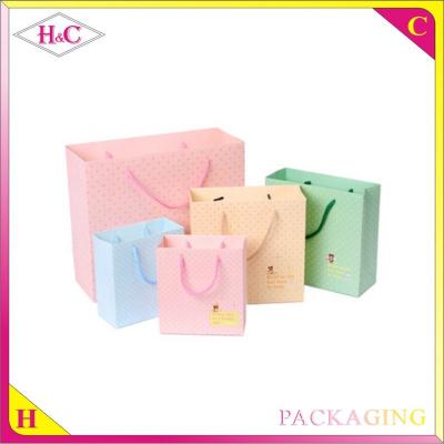China Small Round Poin hand length handle paperboard gift bag for sale