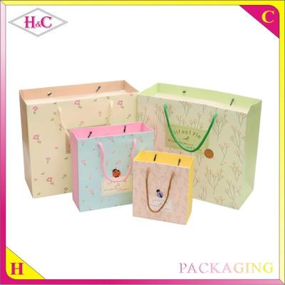 China Flower language hand length handle paperboard upscale gift shopping bag for sale