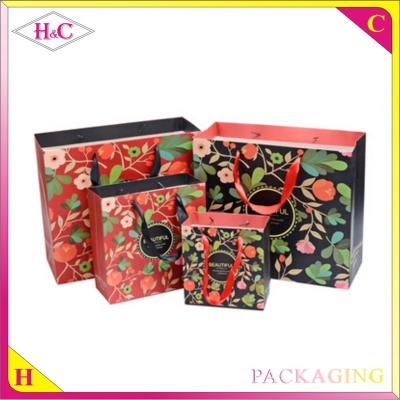 China Kind style hand length handle paperboard gift packaging bag for sale