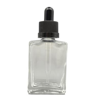 Cina Il cosmetico di vetro del quadrato 30ml imbottiglia il cappuccio innocuo per i bambini del contagoccia per l'olio di cura di capelli in vendita