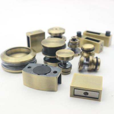 China Frameless SS304 Sliding Door System with Polish Gold Rollers and Frameless Design Style for sale