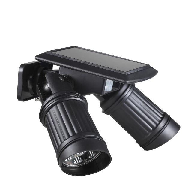 Dual-head solar spotlight illuminating garden area