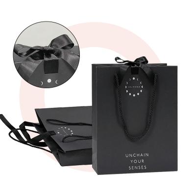 China Custom Design Luxury Black Matte Thick Paper Clothing Packaging Gift Shopping Bag With Logo Ribbon And Handle for sale