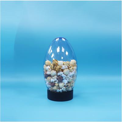 China Unique Egg-Shaped Plastic Candy Popcorn Pistachio Nut Candy Jar Upside Down Flat Cap for sale