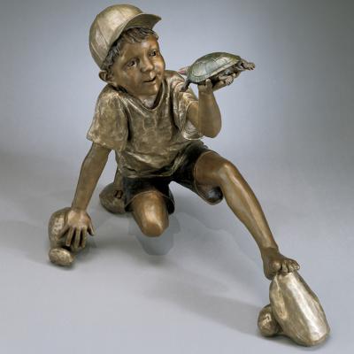 China Kids Metal Sculpture Life Size Bronze Casting Boy And Tortoise Face To Face Garden Statue for sale