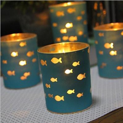 China Electroplate blue glass votive candle holder with hollow sea fish decor for sale