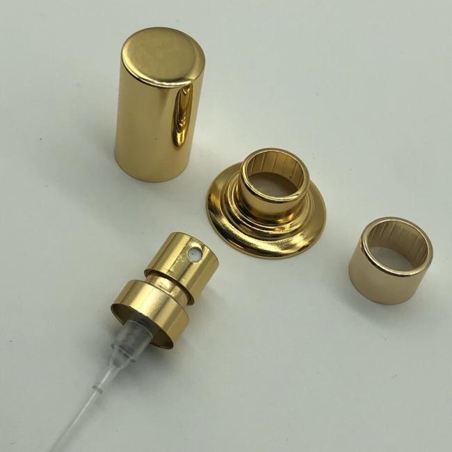 Golden perfume pump close-up showing luxurious gold finish