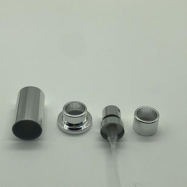 Silver perfume pump mounted on fragrance bottle