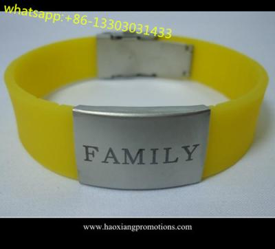 China Custom logo double sided silicone wristband With laser engraving metal for sale