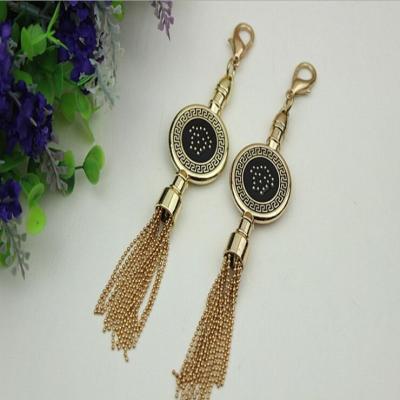 China Novelty DIY high-grade bag hardware accessories light gold drip glue hanging charm with tassel for sale