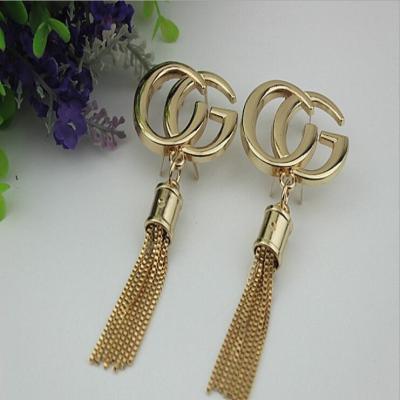China Handbag hardware accessories gold zinc alloy letters logo metal end cap with tassel for sale