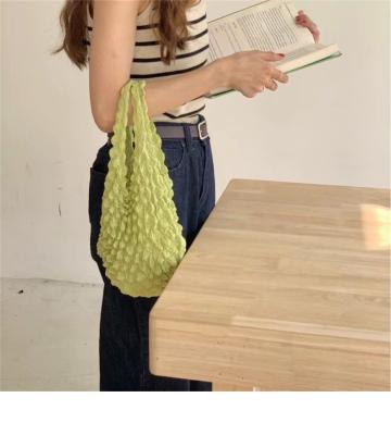 Cina Magic Expansion Fold Pleated Flexible Stretch Mini Bag Large Capacity Bubble Elastic Paddy Portable Shopping Handbag Tote in vendita