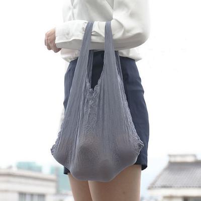 Cina Magic Expansion Fold Pleated Flexible Stretch Mini Bag Large Capacity Bubble Elastic Paddy Portable Shopping Handbag Tote in vendita