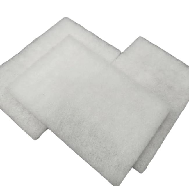 White nylon scouring pad in use on kitchen surface