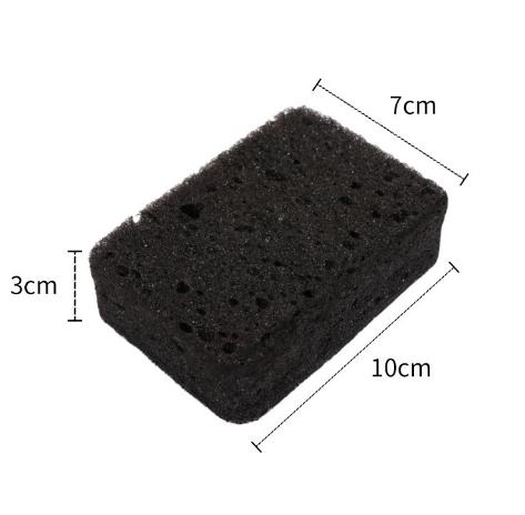 Kitchen sponge in use cleaning a pot