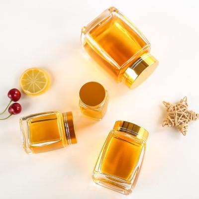 Cina 180 ml 500 ml 700 ml Bottiglia rotonda in vetro di miele a crema con forma rotonda e materiale di vetro in vendita