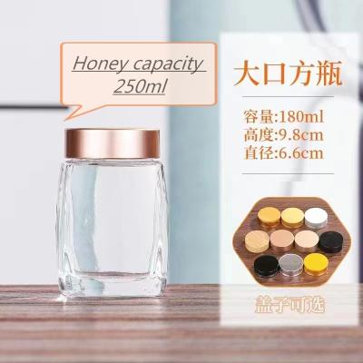 Cina 180 ml 500 ml 700 ml Bottiglia rotonda in vetro di miele a crema con forma rotonda e materiale di vetro in vendita