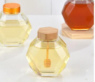 Cina 300 ml di vasetti di miele in vetro esagonale personalizzati con sigillo di sughero e con un becco di legno in vendita