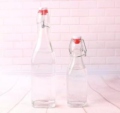 Cina Tipo di tenuta della bottiglia di vetro Cork 150ml 250ml 500ml 1000ml Forma rotonda Swing Top Wine Whiskey Bottles in vendita