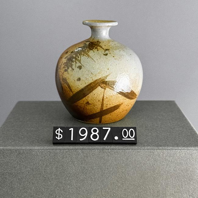 Close-up view of triangular price cube showing embossed lettering detail