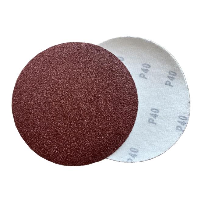 Close-up of red aluminum oxide sandpaper surface texture