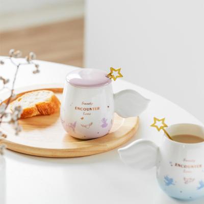 China Enchanting Ceramic Mug with Angel-Wing Handles amp Golden Star Stirrer Adorned with Soft Pink amp Light Blue Gradients for sale