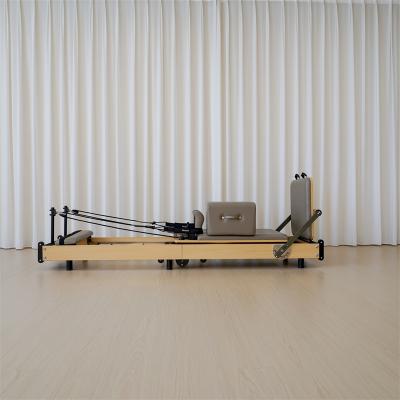 China Adjustable Eco Friendly Pilates Fitness Wooden Foldable Pilates Machine For Space Saving for sale