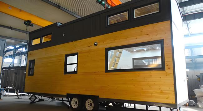 Modern prefab tiny house with wooden exterior and double windows