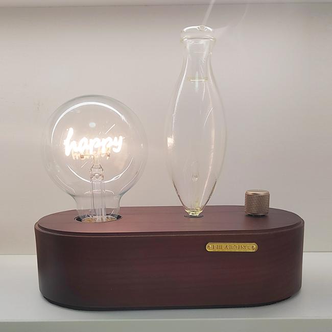Roman Aroma Lamp front view showing wooden base and glass atomizer