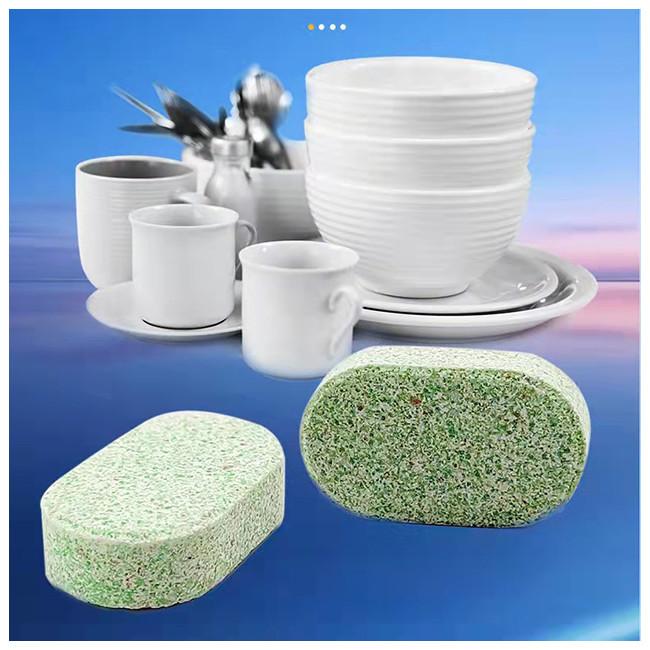 Dishwasher tablets in use with clean dishes