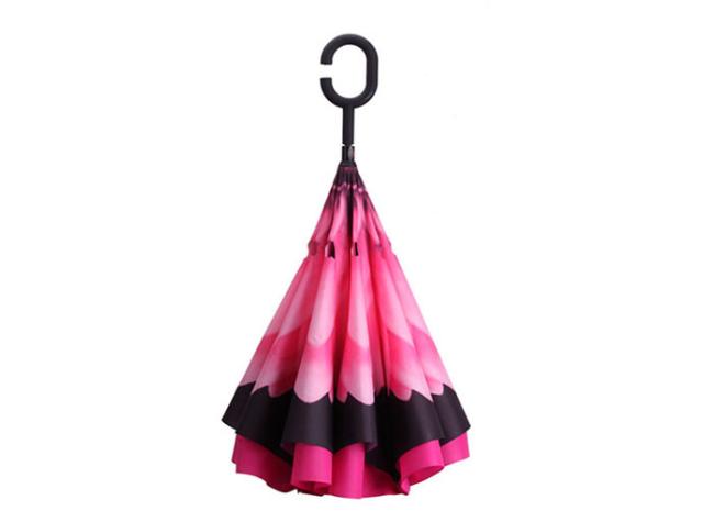 Close-up view of the pink umbrella showing fabric texture and C-shaped handle