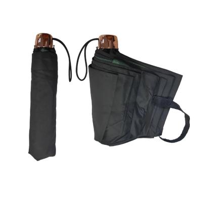 China 8 Ribs Manual 3 Folding Umbrella With Wooden Handle for sale