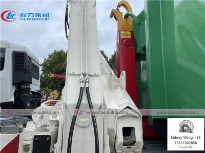 China SINOTRUK HOWO 8x4 LHD Hydraulic Hooklift Garbage Truck With Folded Arm Crane for sale