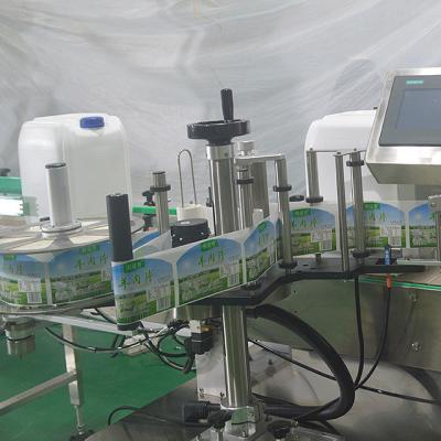 China Máquina de enchimento de azeite de oliva de 20L com 4 cabeças de enchimento e 1 cabeçote de tampa à venda