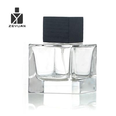 China Luxury 100ml Polished Empty Cube Perfume Atomizer Spray Perfume Bottle With Black Wooden Cap for sale