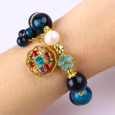 Cina 14MM Energy Healing Crystal Blue Tiger Eye Flower Spinner Charm Bead Bracelet Per Indossare Ogni Giorno in vendita