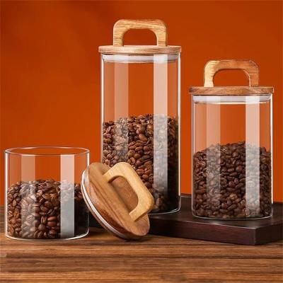 中国 700ml 1000ml 1400ml large wide mouth heat-resisting glass storage jars with wooden lids 販売のため