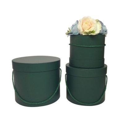 中国 さまざまな色のカスタム段ボールギフトラウンドシリンダーブーケ花箱パッケージング付きハンドル 販売のため