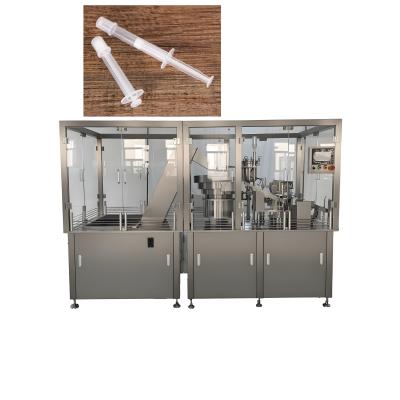China Automatic Plastic Syringe Filling and Plugging Machine for Liquid and Gel for sale