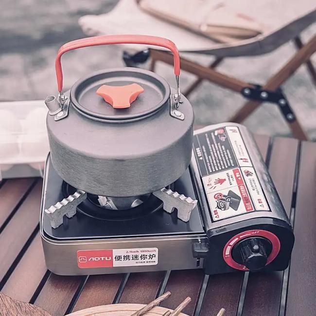 Portable butane gas stove in use during camping