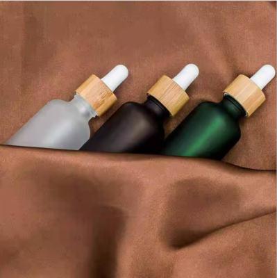 China China High End Essential Bottle Bamboo Ring Rubber Head Glass Cusp Dropper Essential Glass Bottle for sale