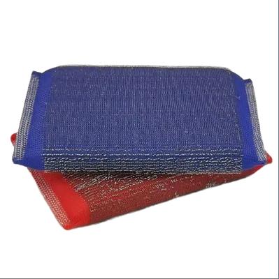 Stainless steel scourer in use on cookware