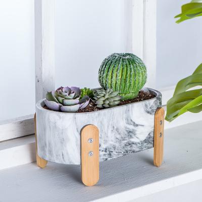 中国 Succulentsの植物の鍋の小型植木鉢の卓上の植木鉢はタケ フィートのセメントの鍋が付いている質の鍋プランターに大理石模様をつけた 販売のため