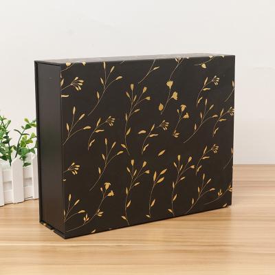 China Folding Gift Box Customized Black Cardboard Cosmetic Packaging Box with Gold and Silver Stamping for sale
