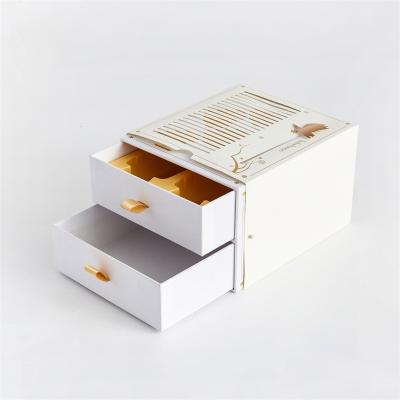 中国 カスタマイズされた創造的なくり抜かれた化粧品箱の包装の紙箱は二重層の引出し箱をカスタマイズした 販売のため