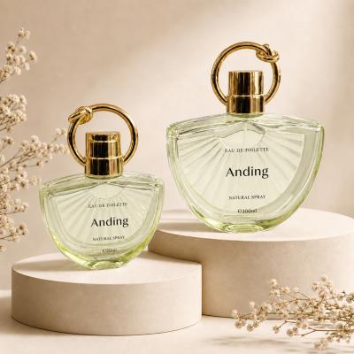 China 50ml 100ml Glass Perfume Bottle Unique Ring Cap Handbag Style Empty Spray for sale