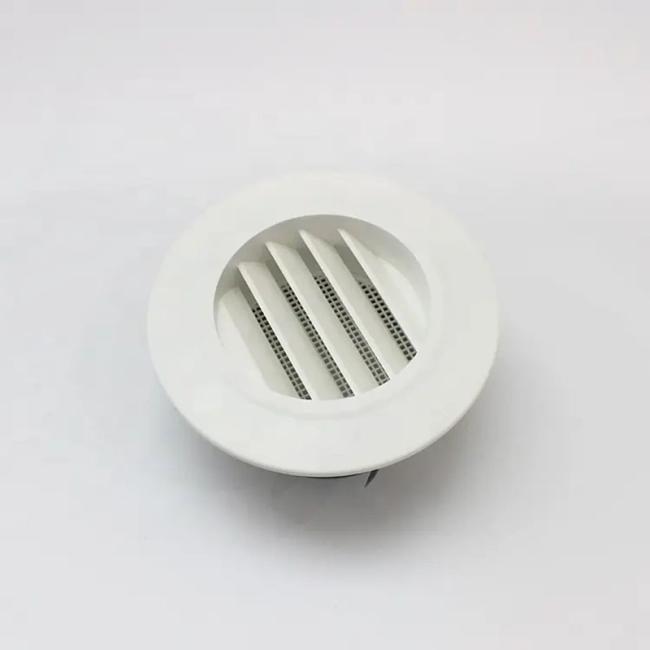 Modern circular ceiling vent cover installed in commercial setting